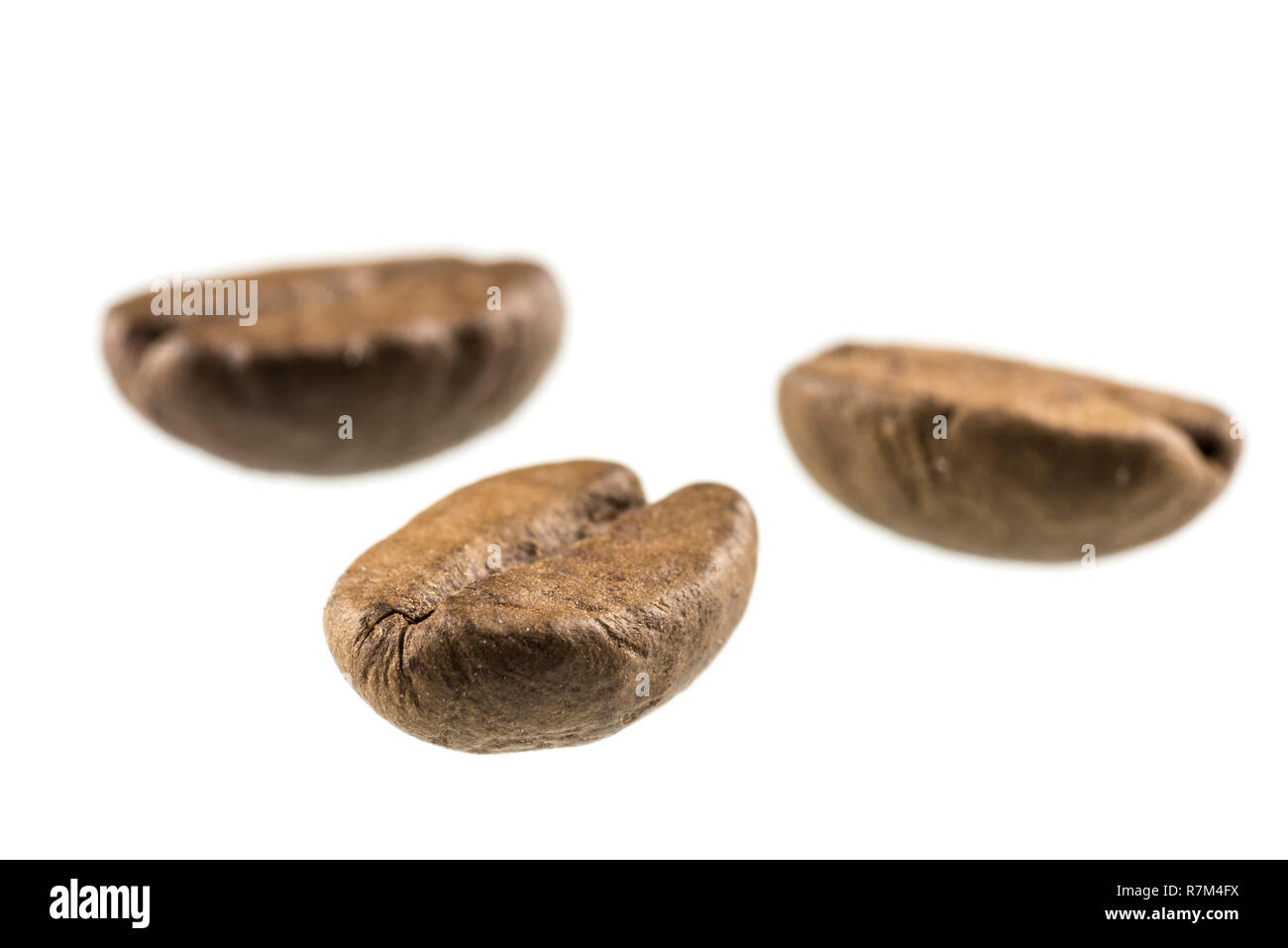Three coffee beans isolated over white background Stock Photo - Alamy