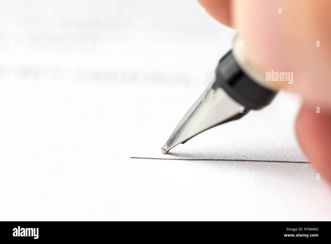 Macro shot of signing contract with ink pen Stock Photo - Alamy