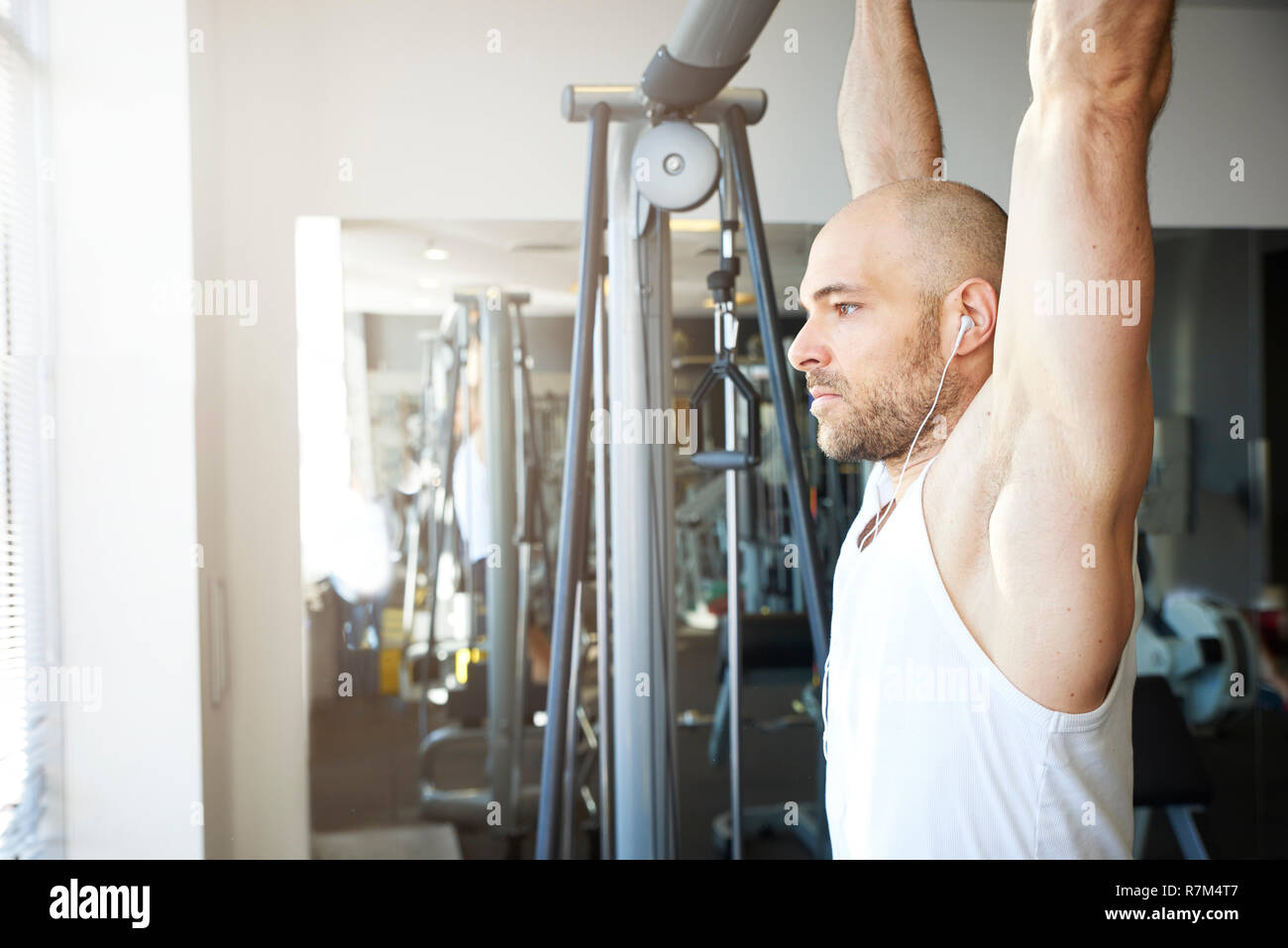 Shot of male athlete doing pull up training in the gym Stock Photo - Alamy