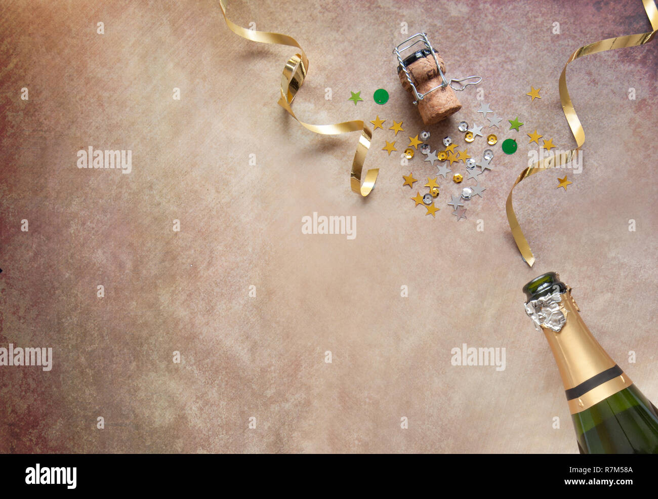 Decorations exploding from a bottle of champagne Stock Photo - Alamy