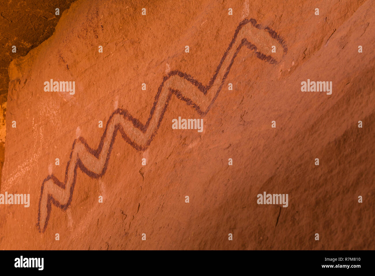 A dramatic snake petroglyph painted on wall of Moon House Ruin on Cedar ...