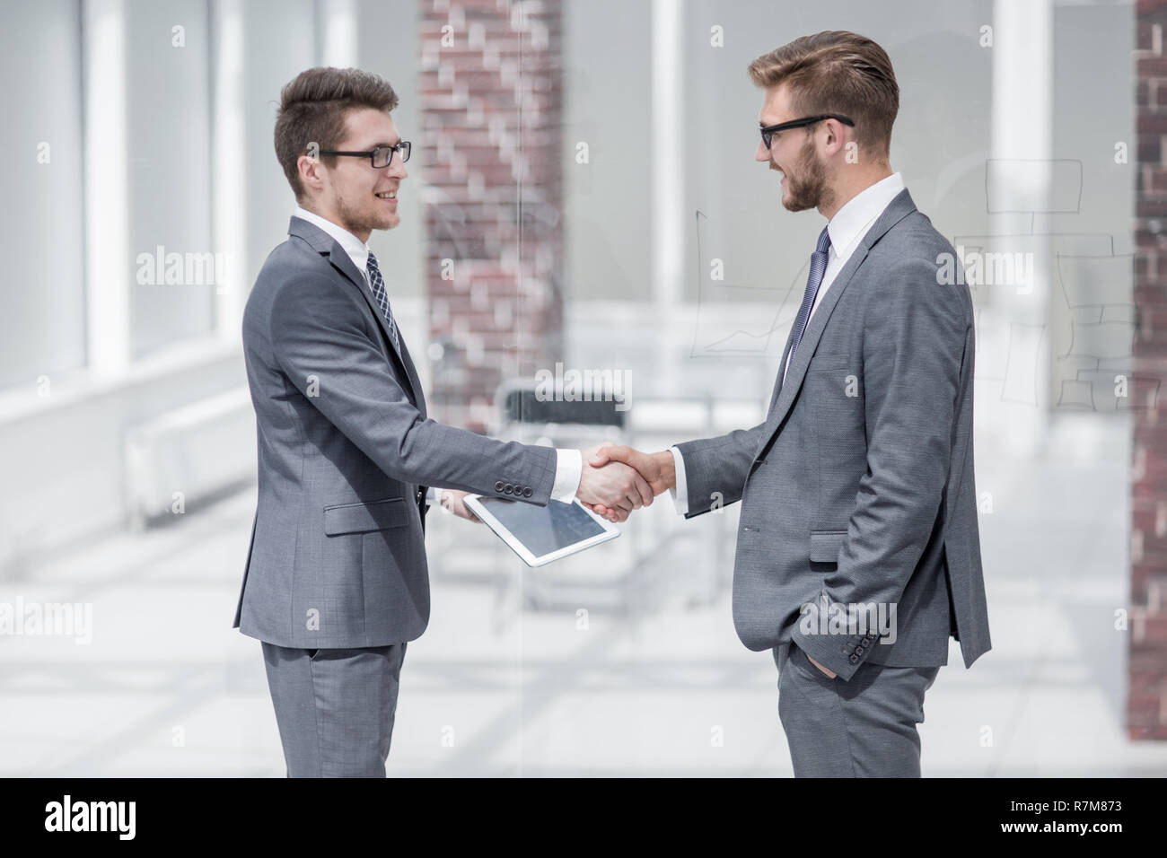 colleagues greet each other with a handshake Stock Photo - Alamy