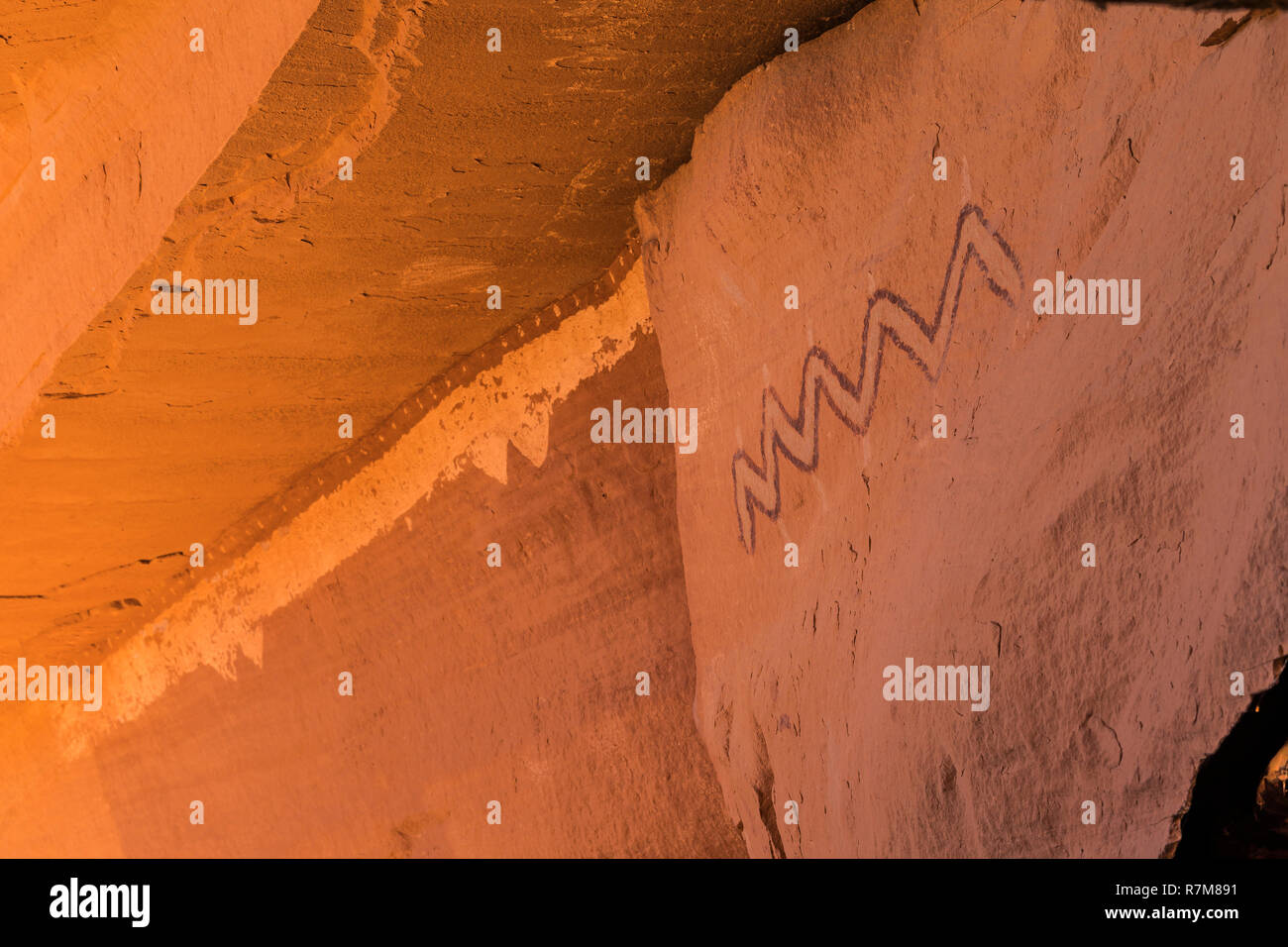 A dramatic snake petroglyph painted on wall of Moon House Ruin on Cedar ...