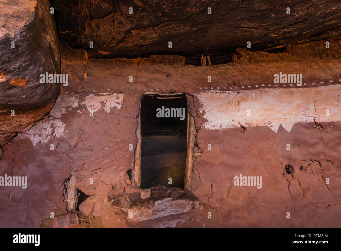 Doorway and painted decorative symbol along interior passage behind a ...