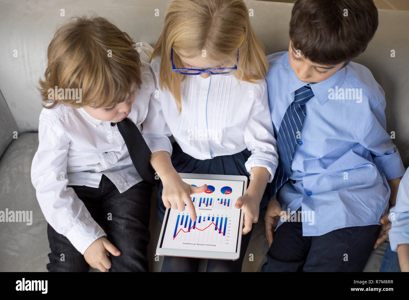 Little children on business meeting working and sharing ideas in office ...