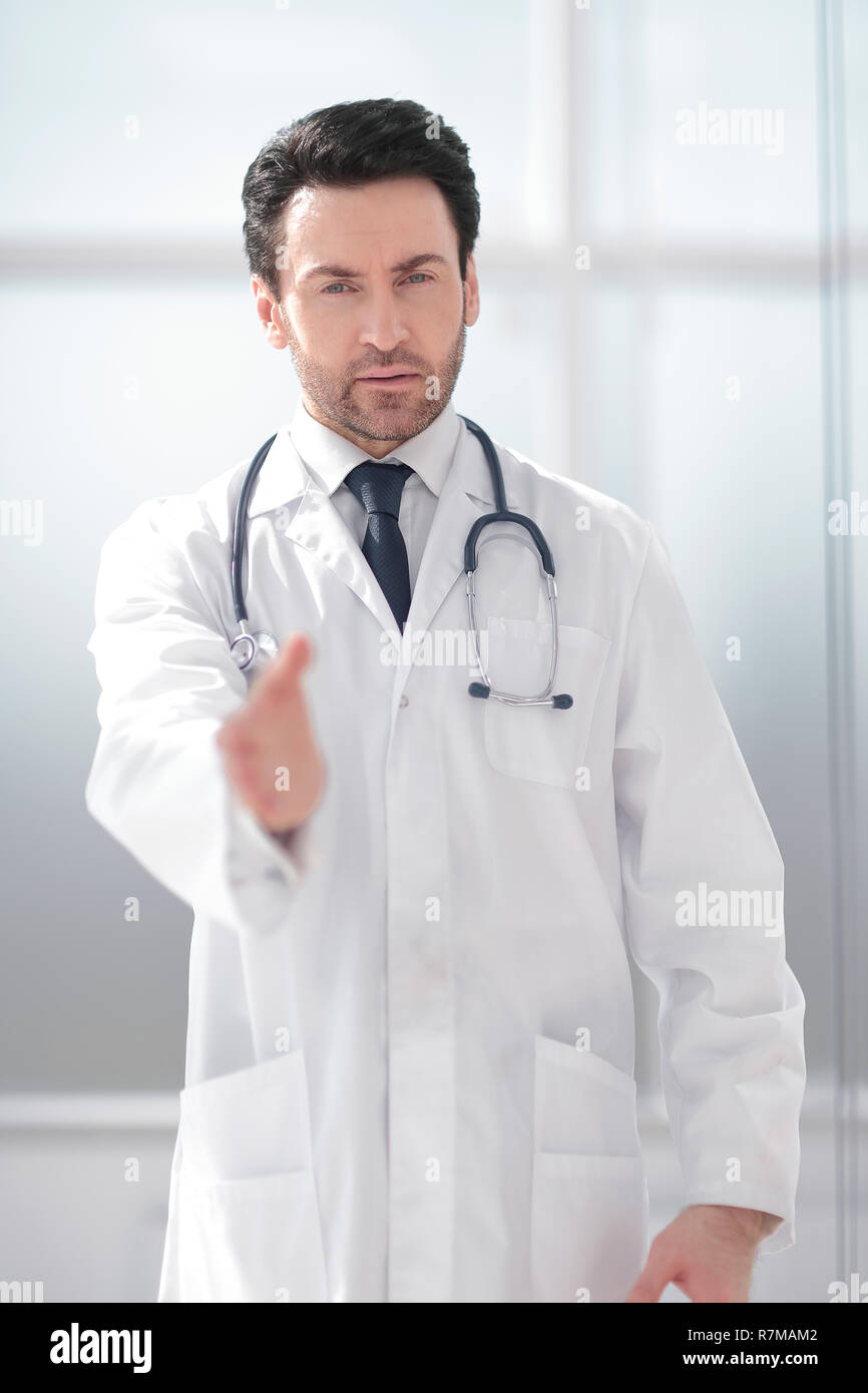 background image of the doctor holding out his hand for greeting Stock ...