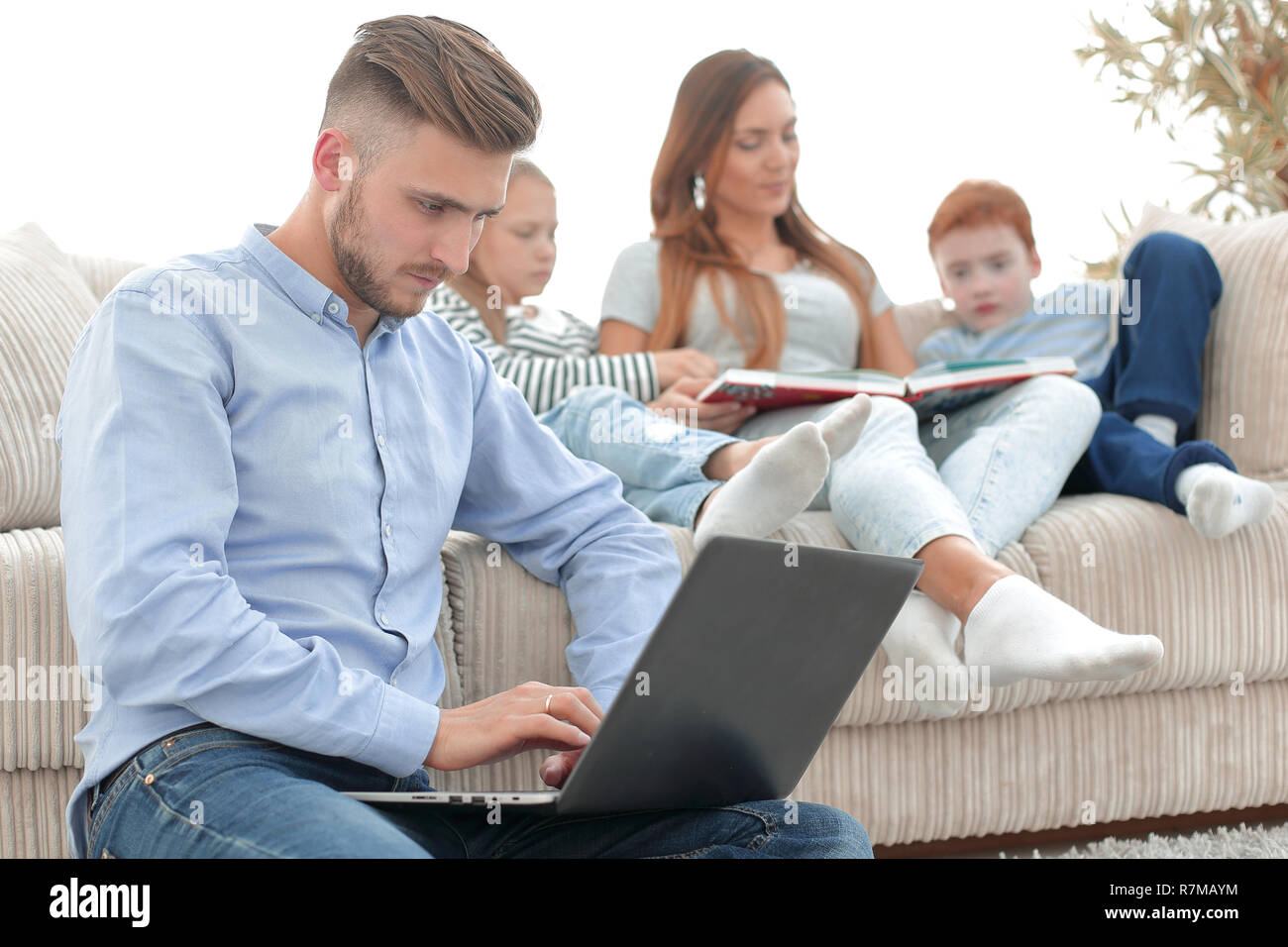 modern man sitting in his living room Stock Photo - Alamy