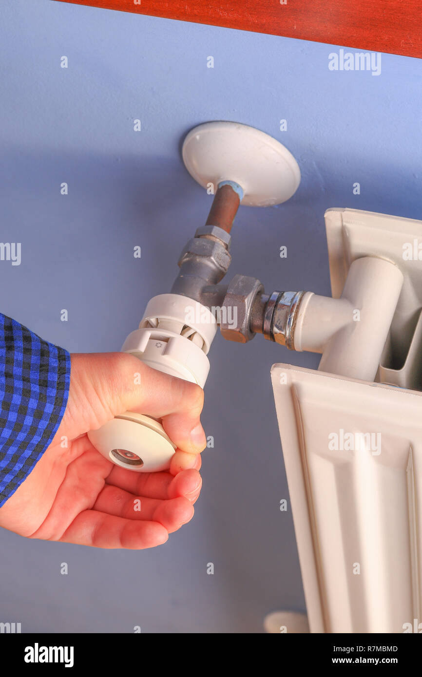 Hand Adjusting The Knob Of Heating Radiator Stock Photo - Alamy