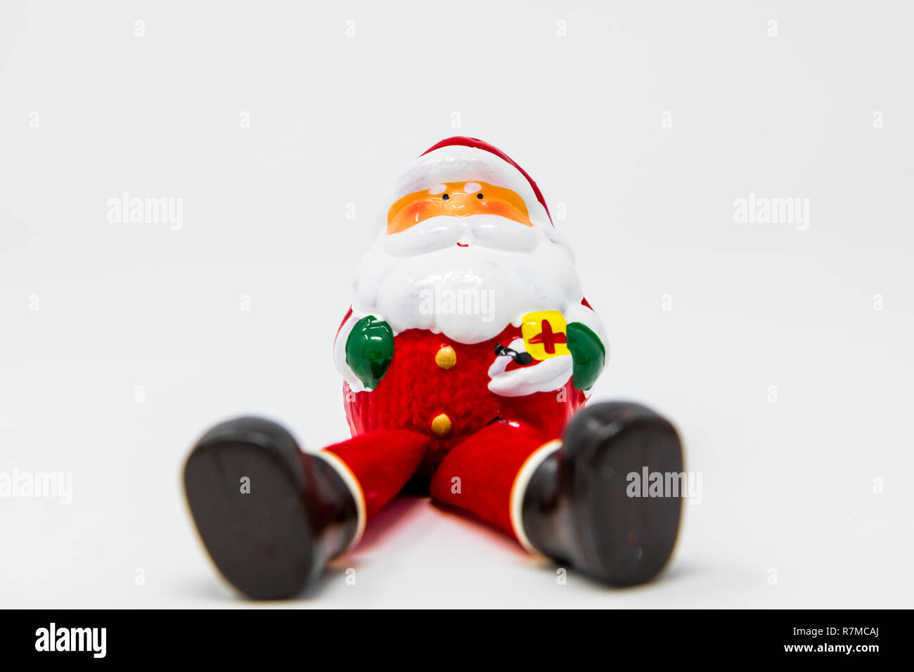 Small ceramic figure of Father Christmas with fabric red trousers and ...