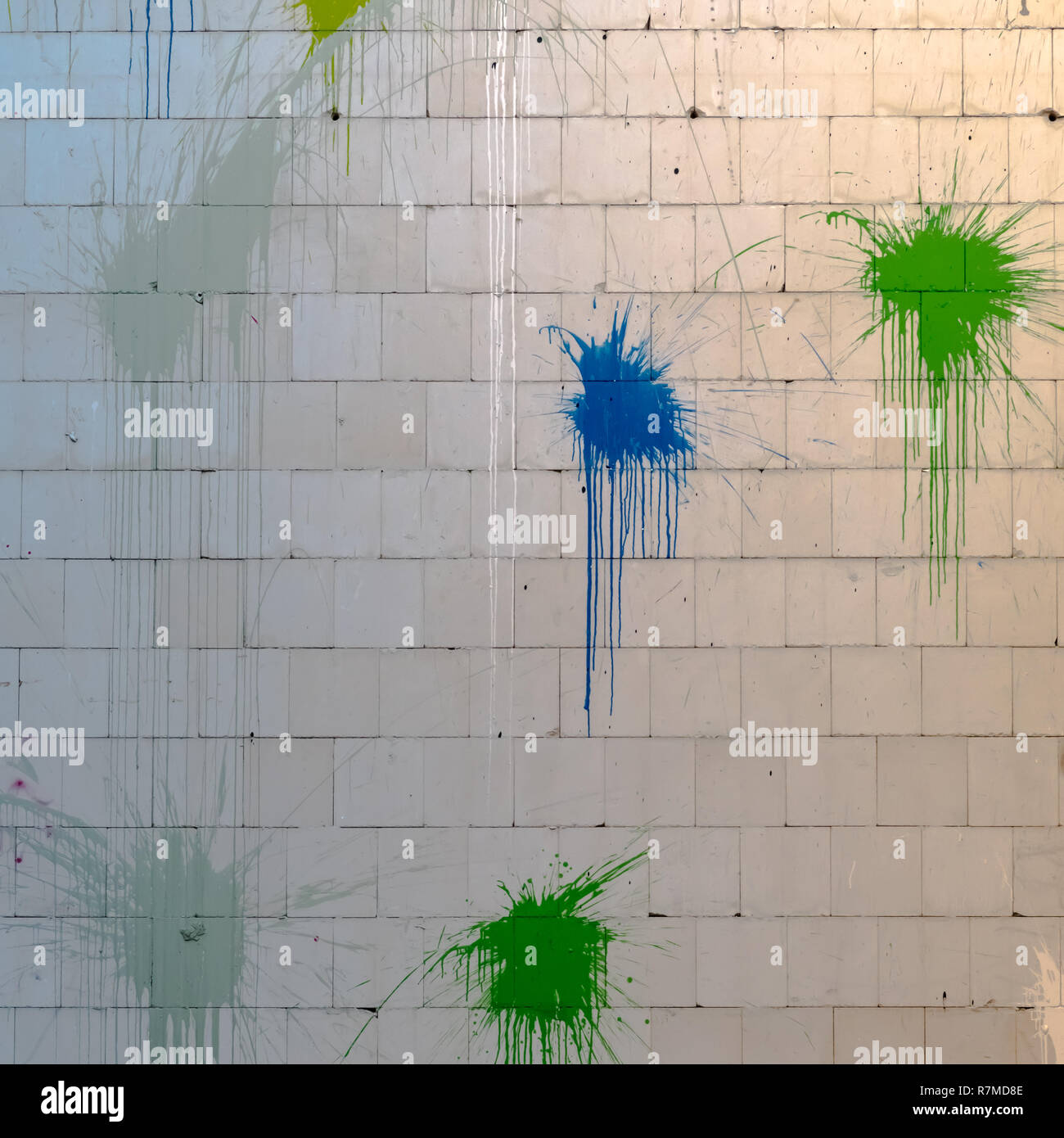 The splashes of color on the wall made of concrete paving stones Stock ...
