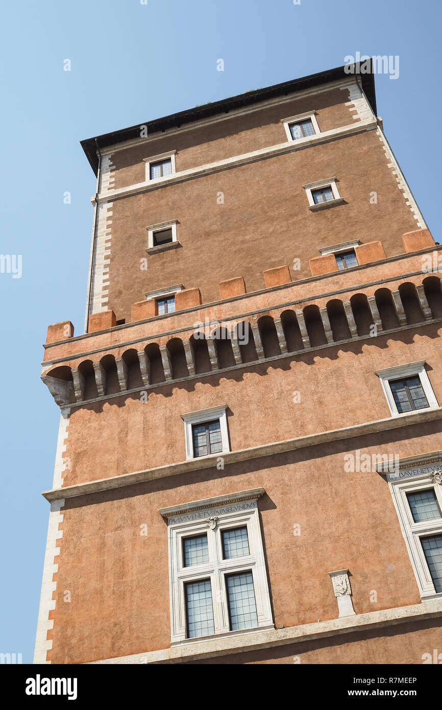 Roman architecture, tower with orange mediterranean facade and windows ...