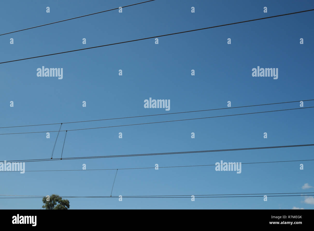 Electrical wires parallel, train cables overhead with blue sky Stock ...