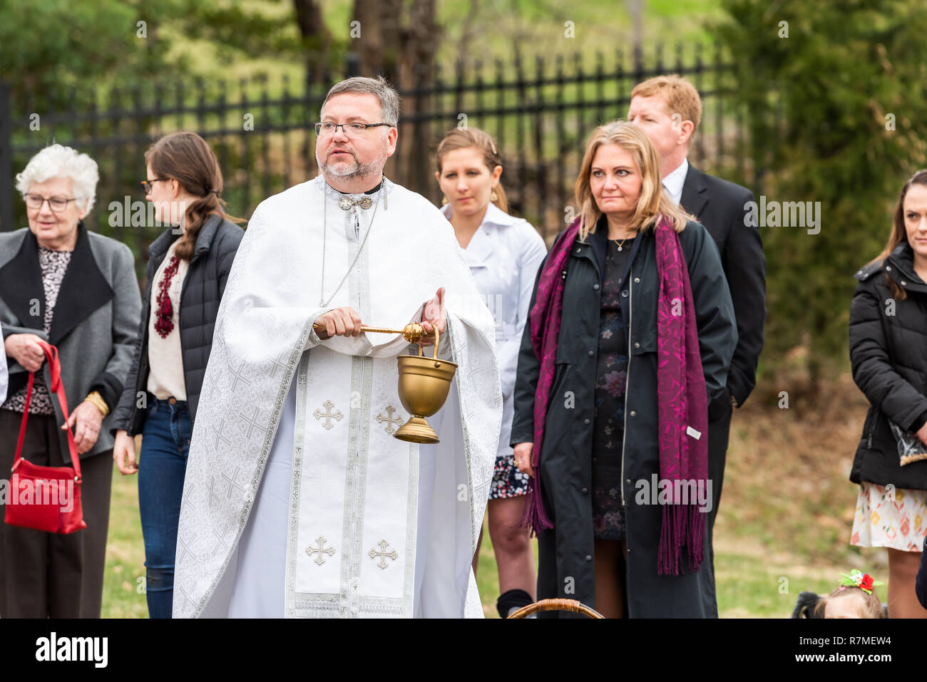 Washington DC, USA - April 1, 2018: People, priest praying, holding ...