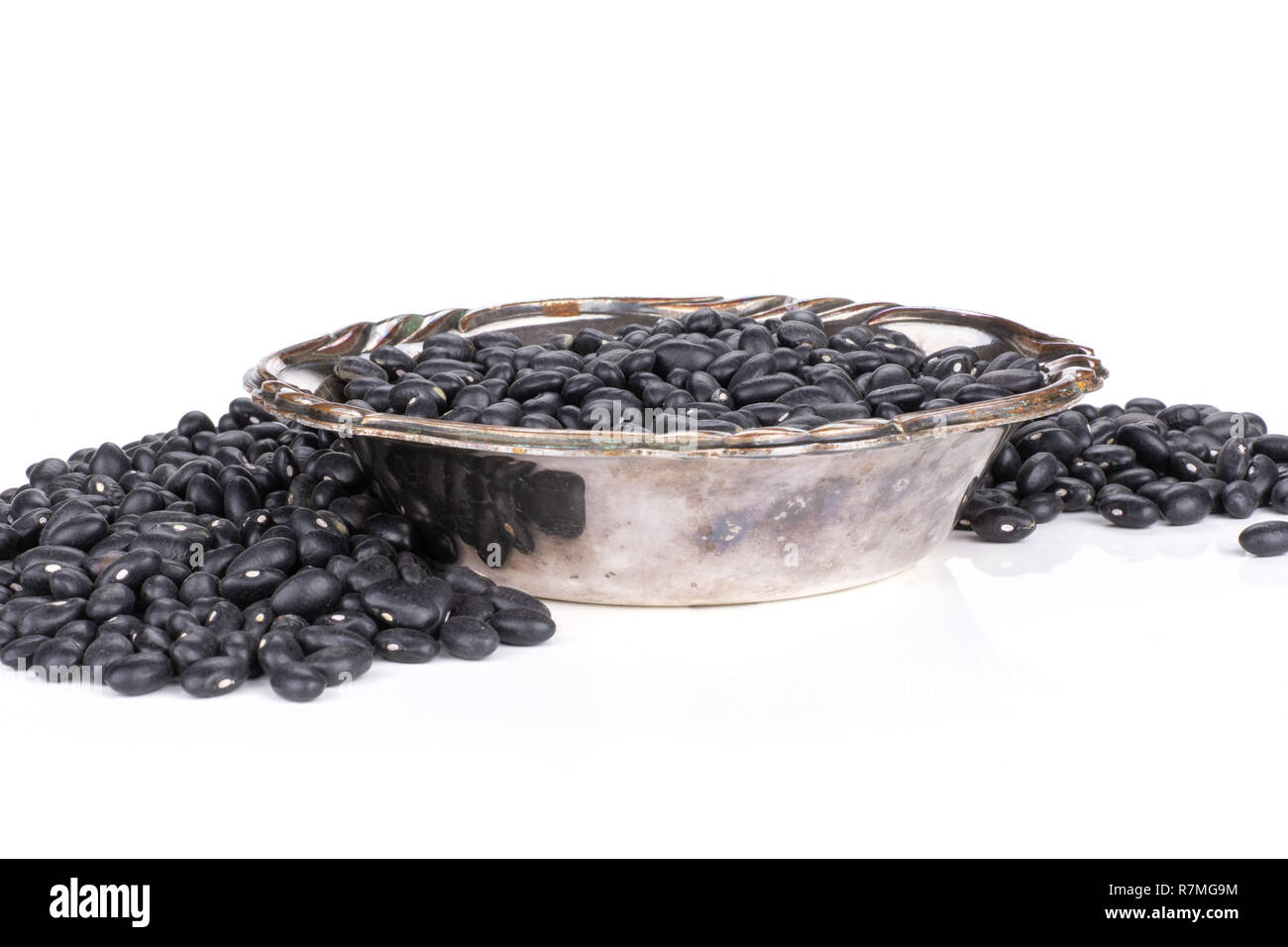 Lot of whole raw black turtle beans in old iron bowl isolated on white ...