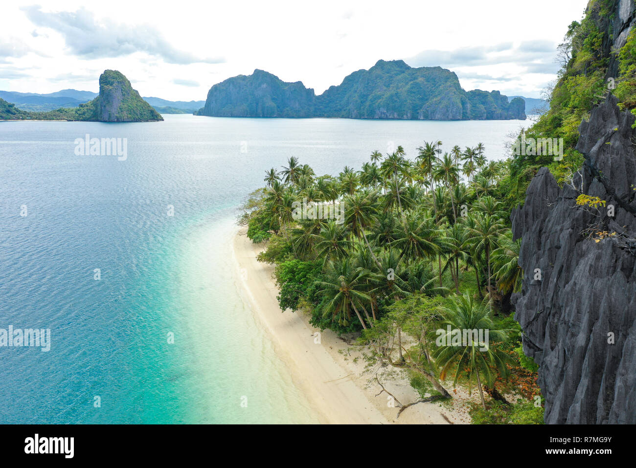 Aerial drone view of turquoise coastal waters and limestone cliffs in ...