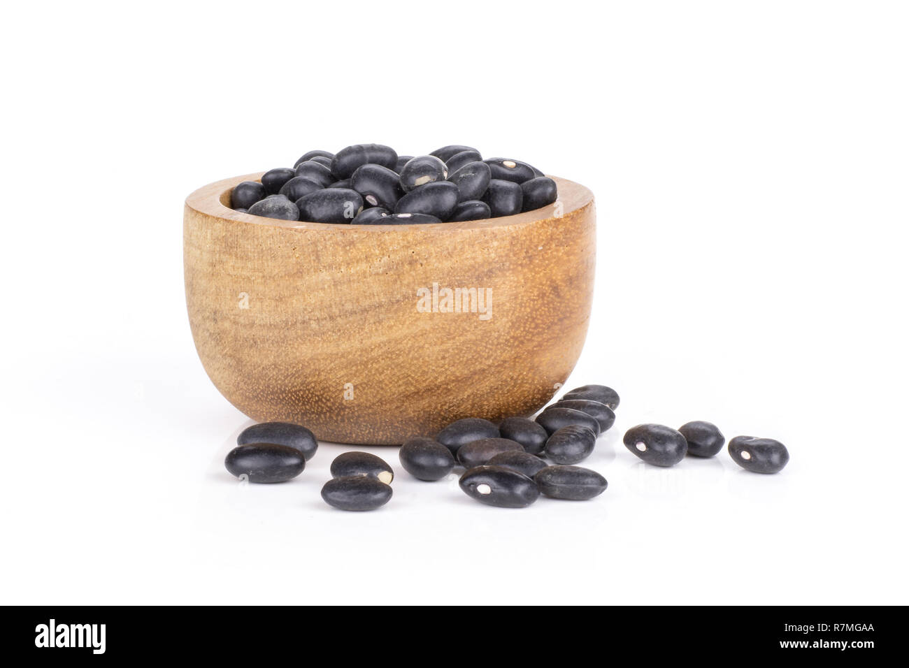 Lot of whole raw black turtle beans with wooden bowl isolated on white ...