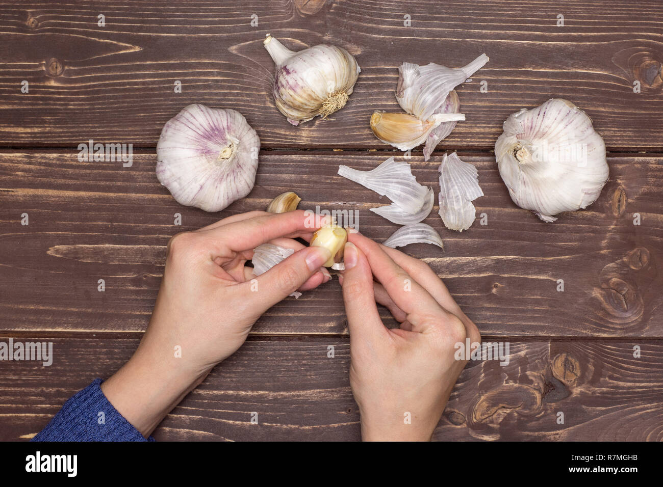 Woman hands are spliting garlic cloves. recipe step by step baked ...
