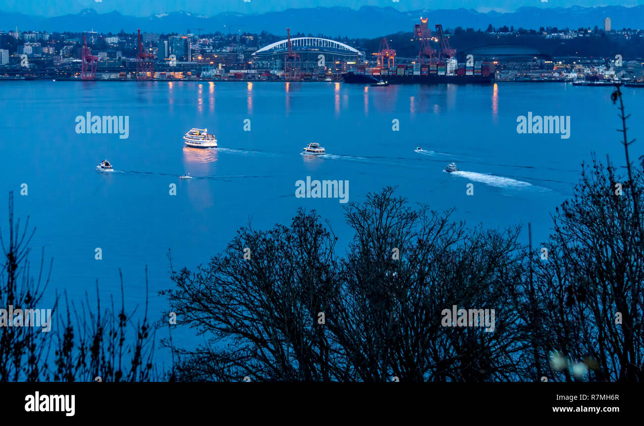 A view of boats with lights and the Seattle skyline at night Stock ...