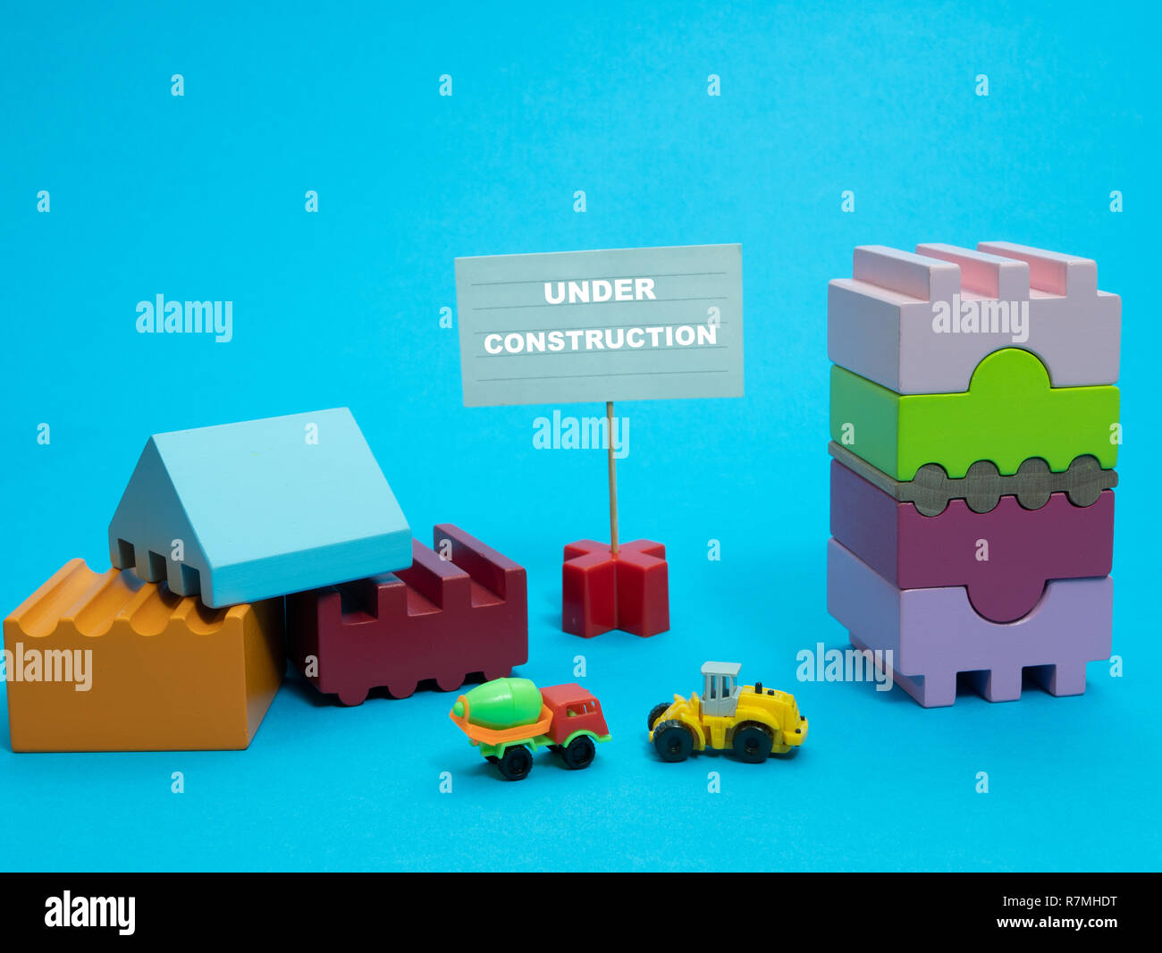 small sign stand under construction among builder toys. any occupation ...