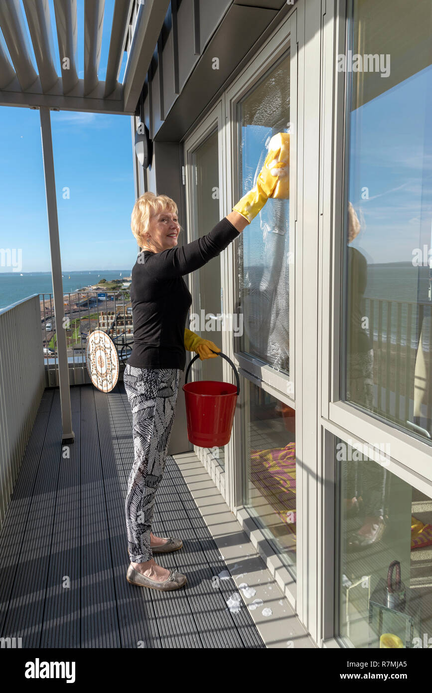 Cleaning woman balcony hi-res stock photography and images - Alamy