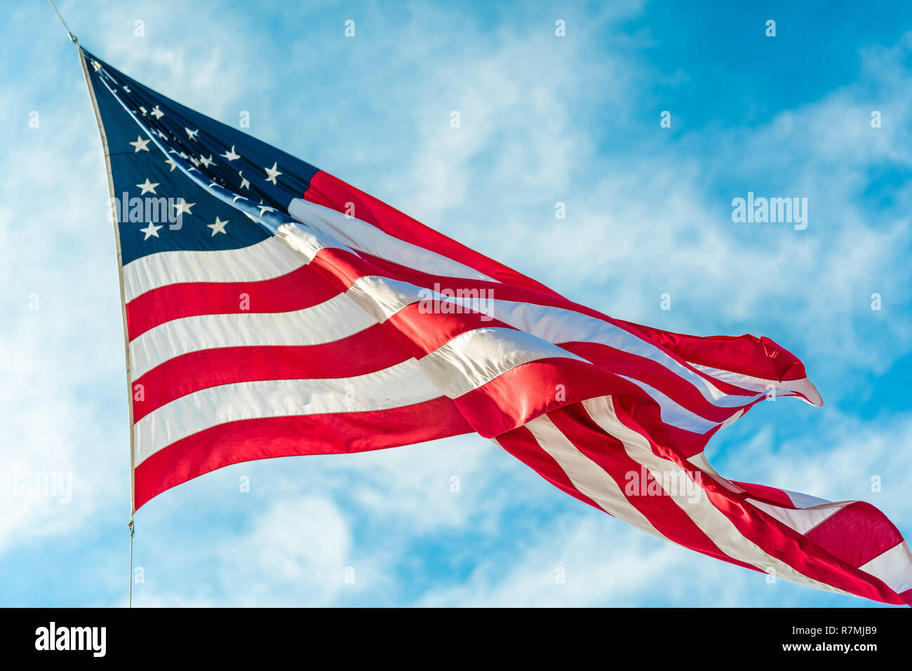 American flag waving in cloudy hi-res stock photography and images - Alamy