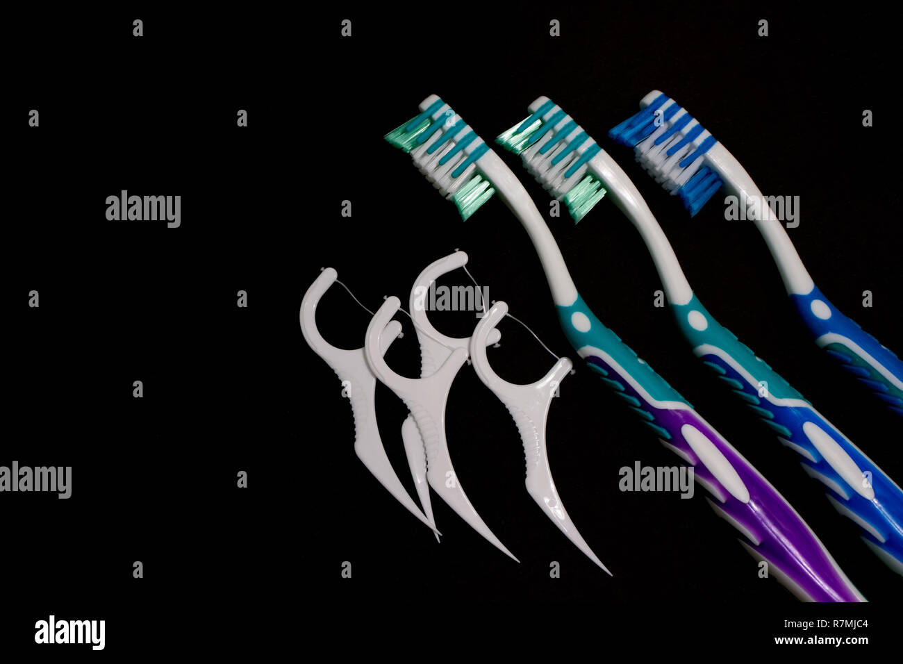 Colorful toothbrushes and toothpicks isolated on black background Stock ...