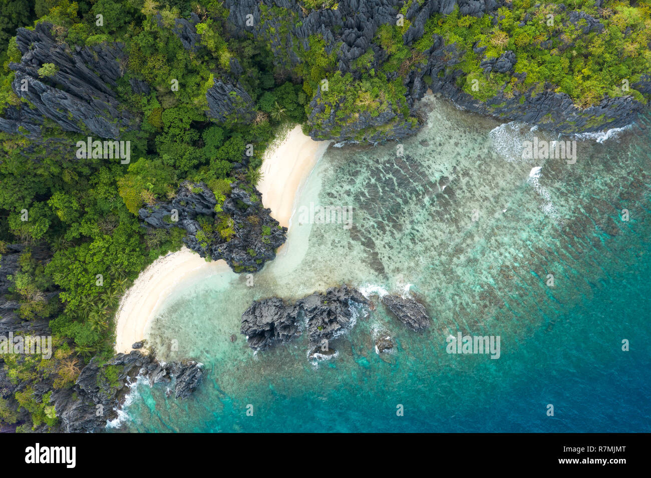 Aerial drone view of turquoise coastal waters and limestone cliffs in ...