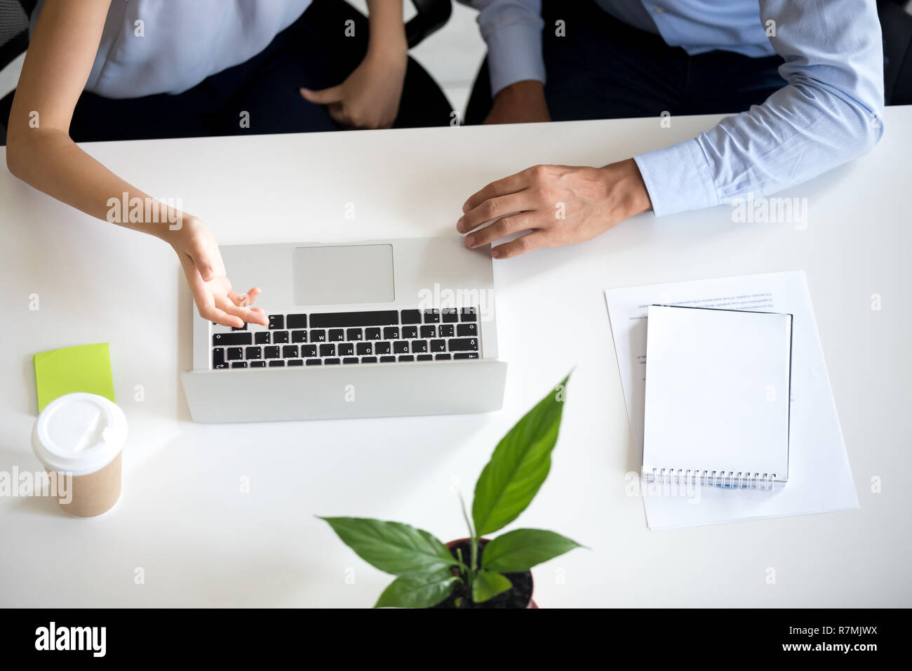 Employees colleagues using laptop together, discuss online proje Stock ...