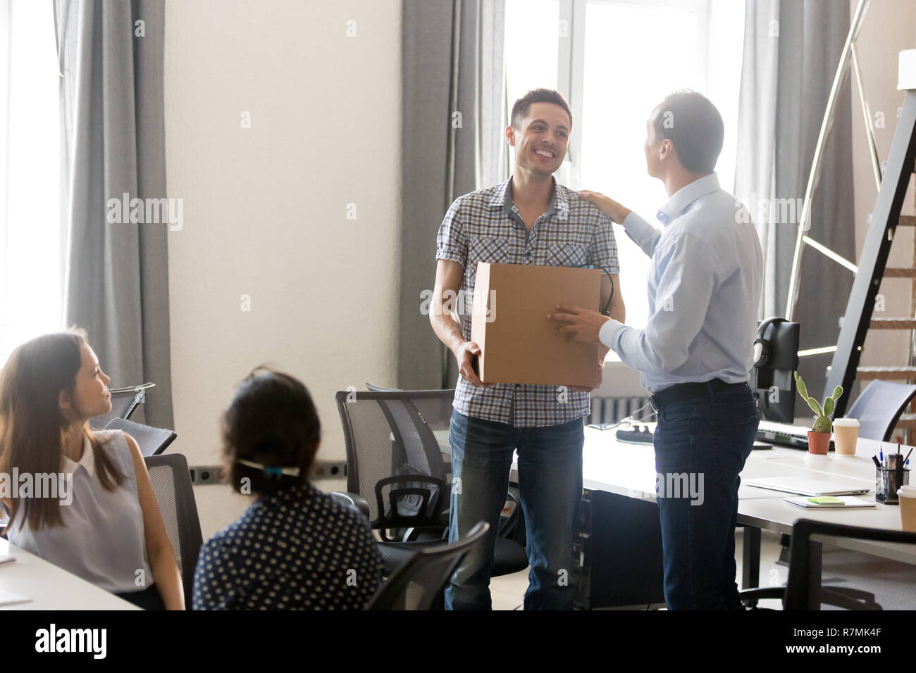 Boss is introducing just hired male employee Stock Photo - Alamy