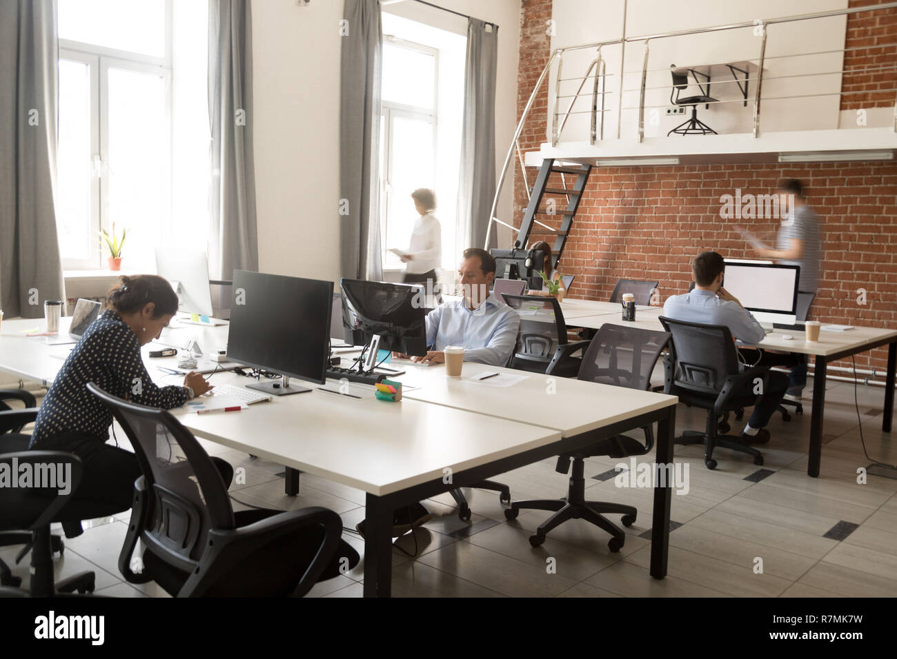 Serious team of employees working in modern office Stock Photo - Alamy