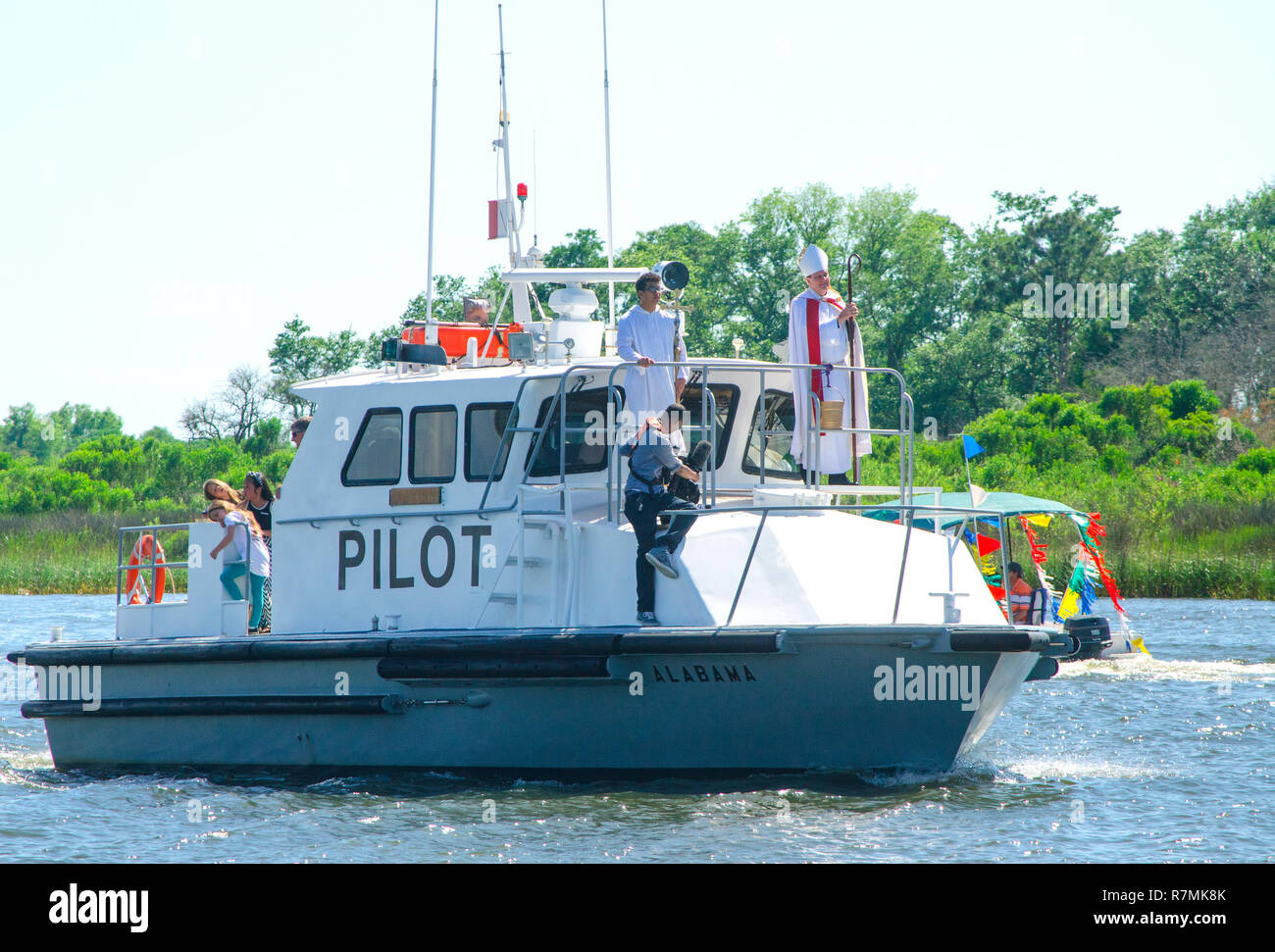 Catholic Archbishop Thomas J. Rodi, front, rides the pilot boat during ...
