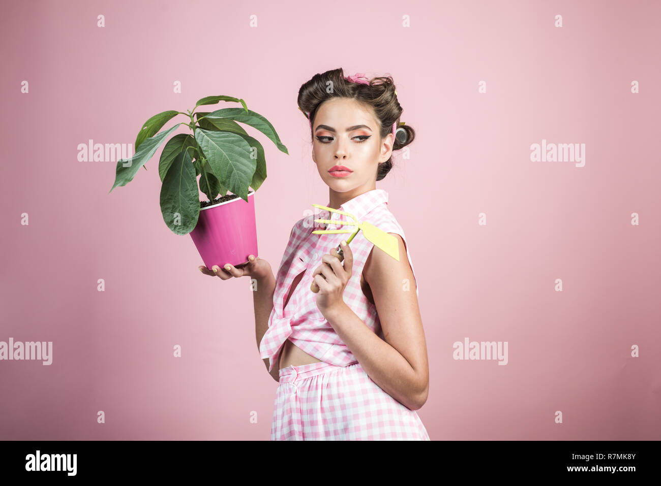 pin up woman with trendy makeup. retro woman growing plants. Garden ...