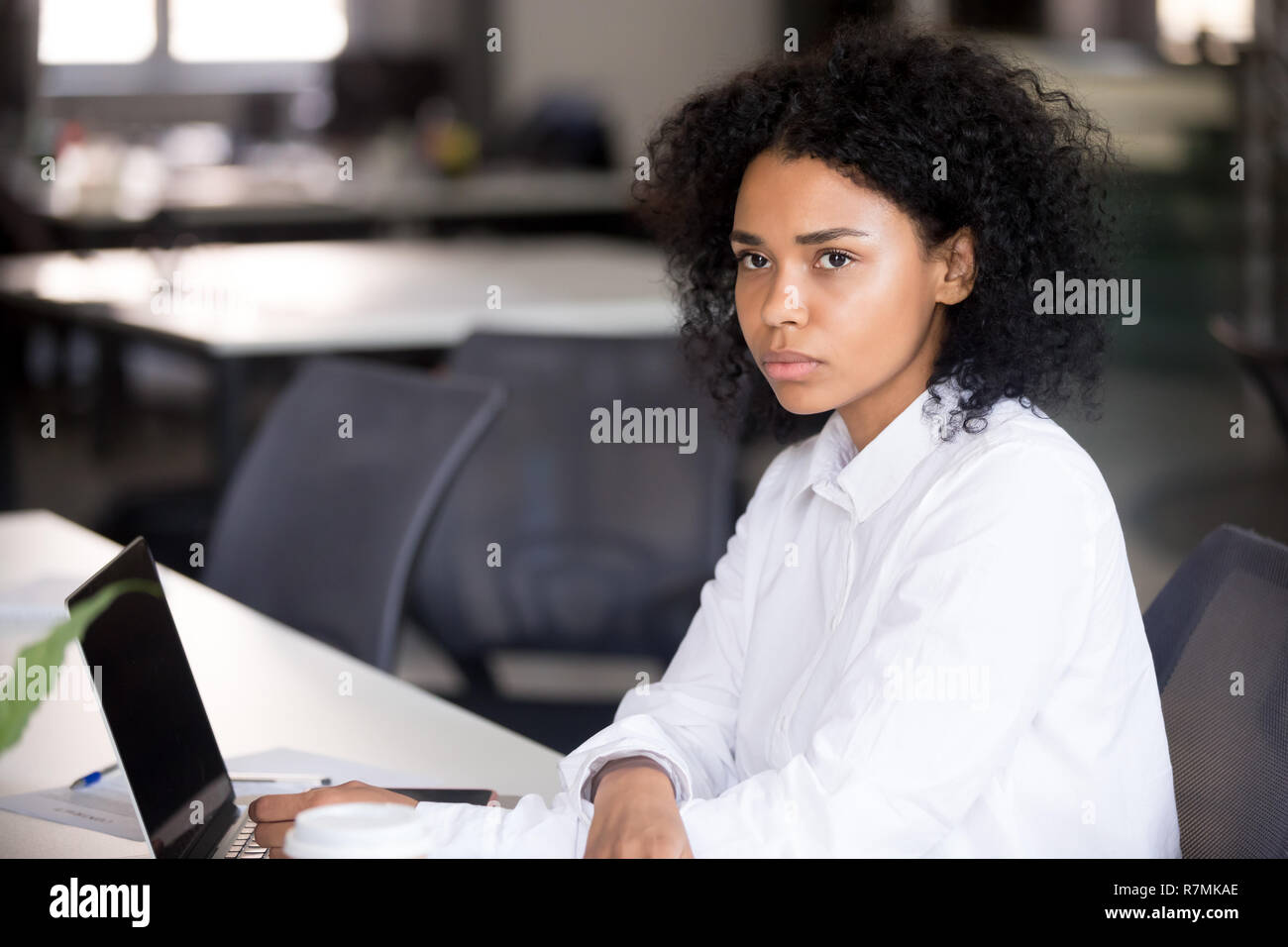 Focused African American woman looking in distance at workplace Stock ...