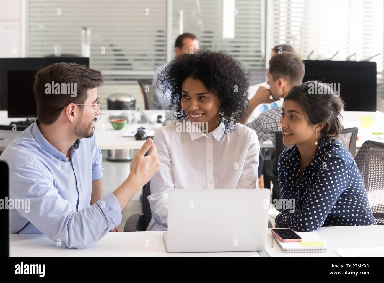 Diverse colleagues discussing online project at workplace Stock Photo ... Diverse colleagues discussing online project at workplace Stock Photo ...