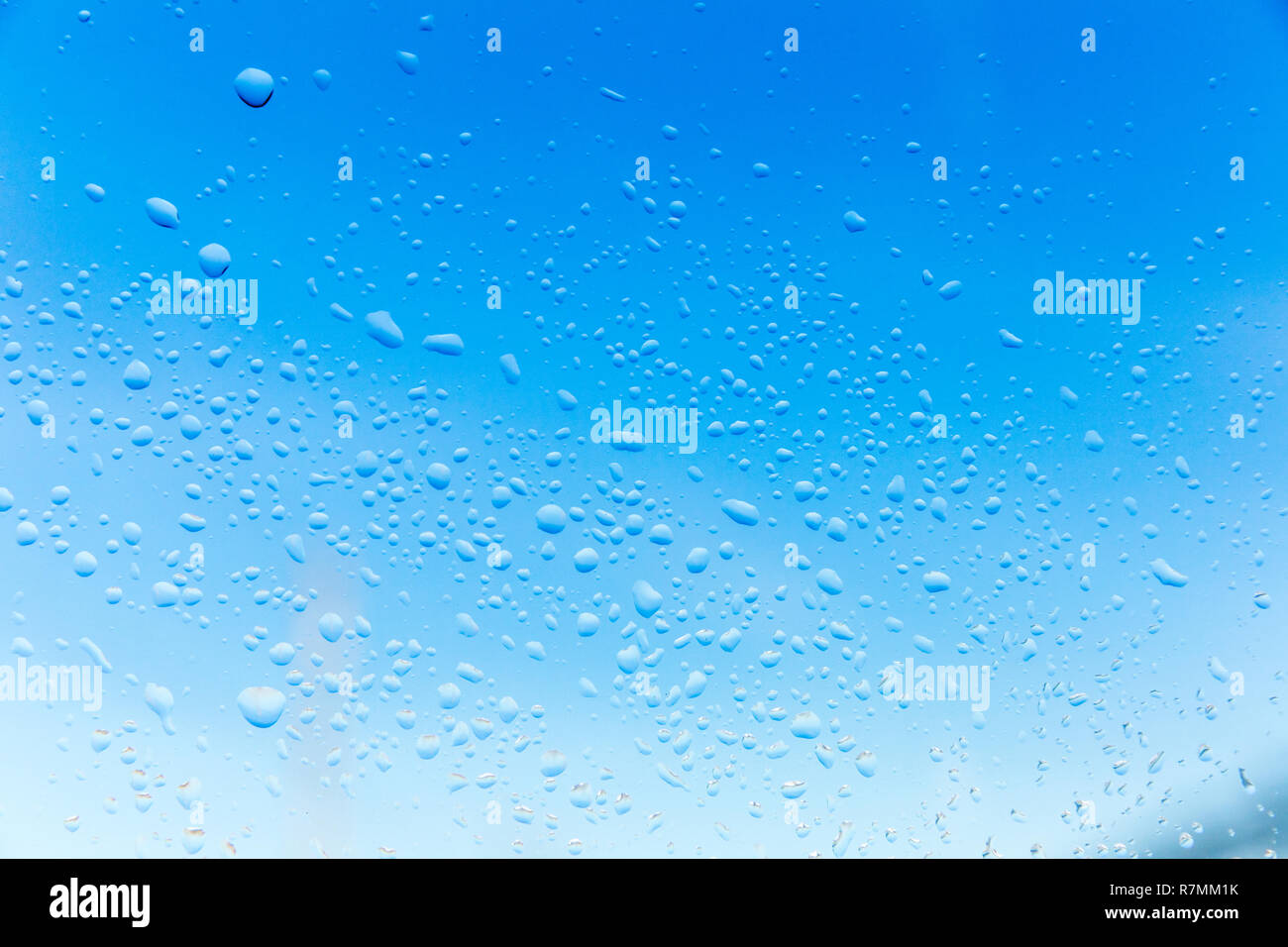 Texture of water droplets on glass window in fall or winter setting ...