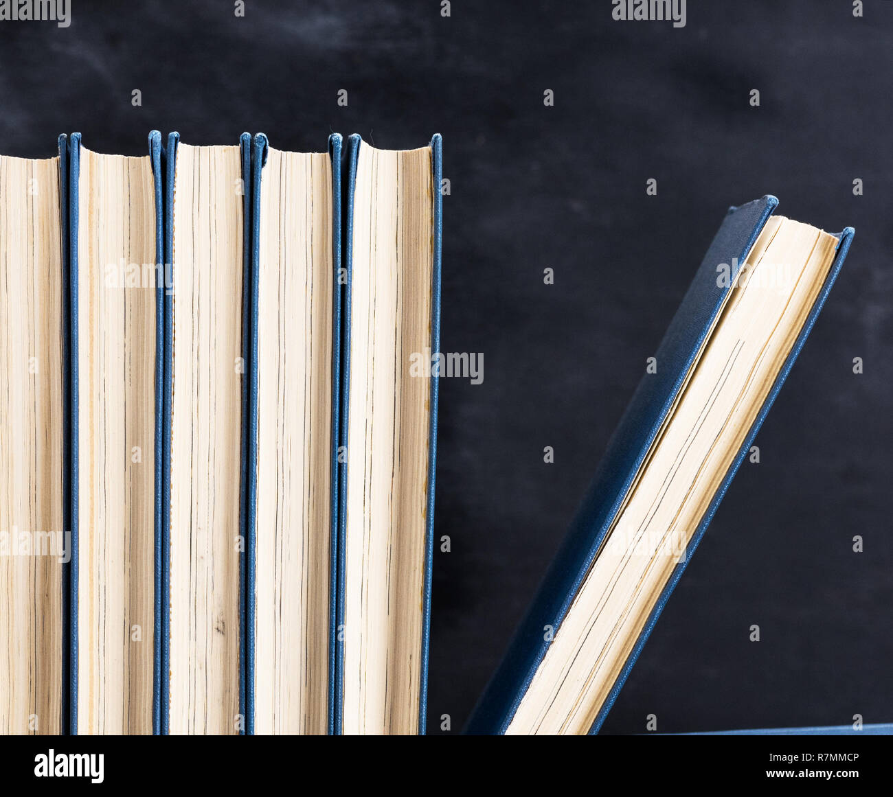 books with blue cover, black background, close up Stock Photo - Alamy