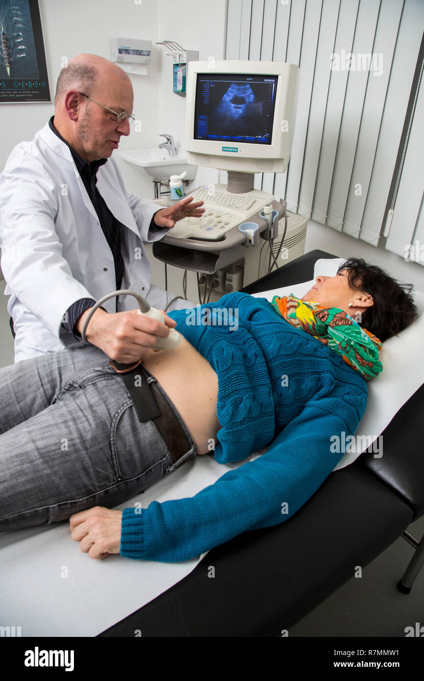 Medical practice, internist examining a patient with an ultrasound ...