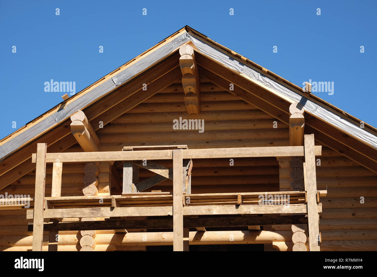 Process of wooden house straight roof slope mounting front view. Wooden ...