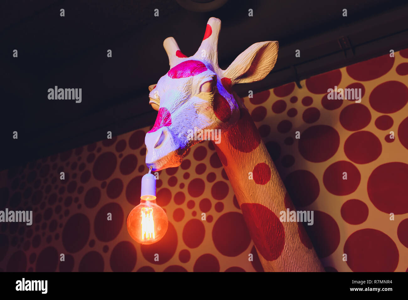 the statue Giraffe with stone wall background Stock Photo - Alamy