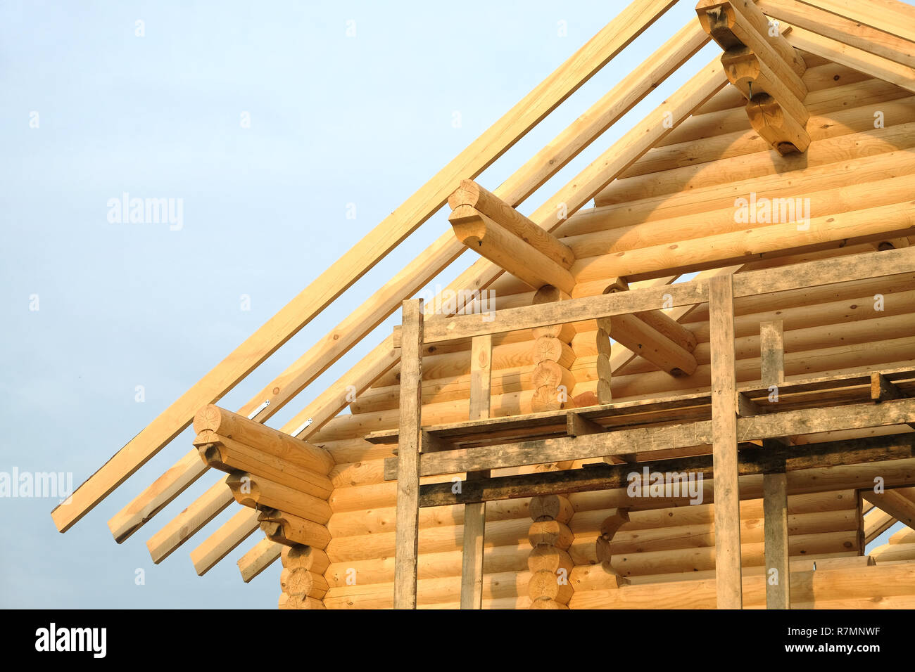 Process of wooden house straight roof slope mounting side view. Wooden ...