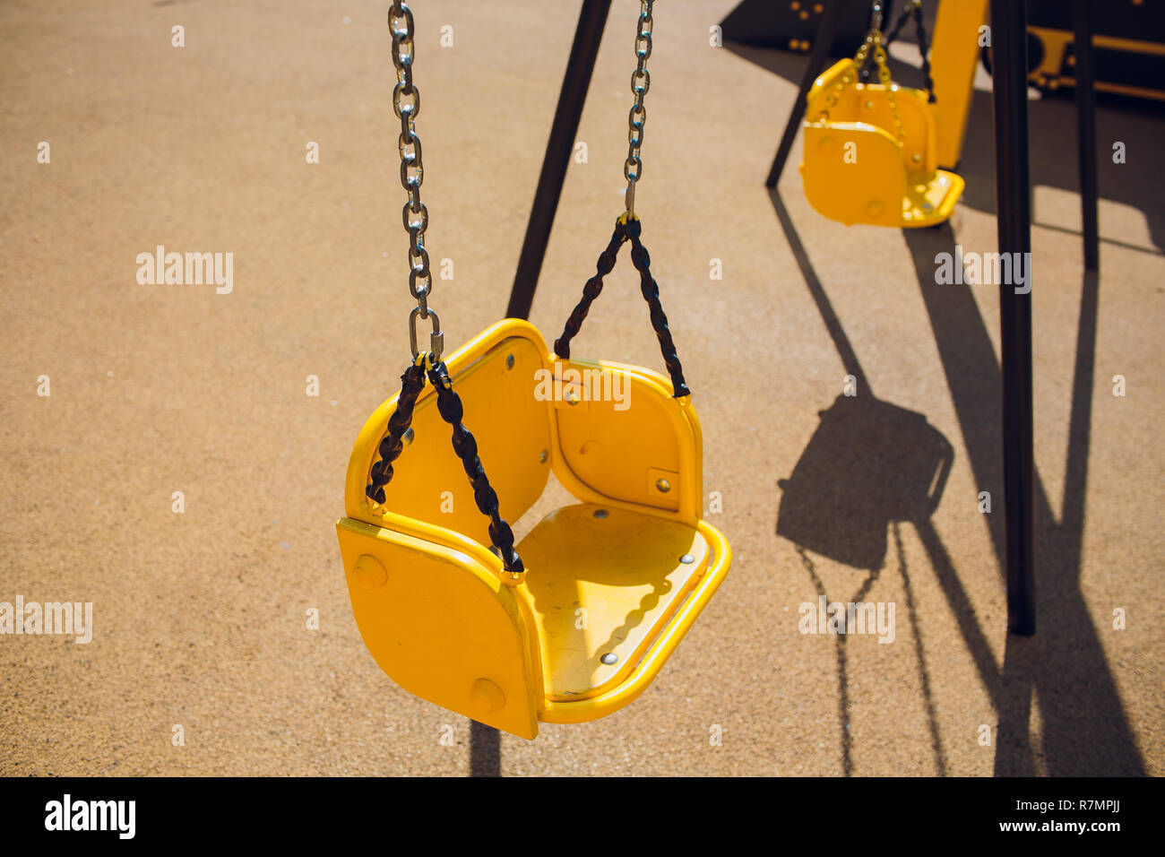 Empty chain swing swings in children playground Stock Photo - Alamy