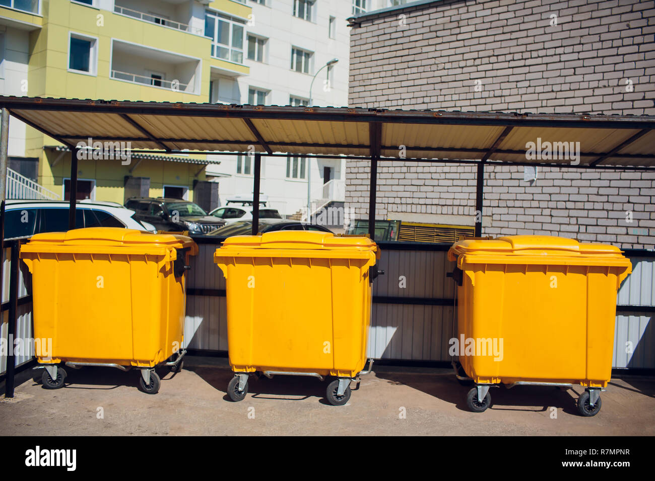 yellow and green street garbage containers n the street Stock Photo - Alamy
