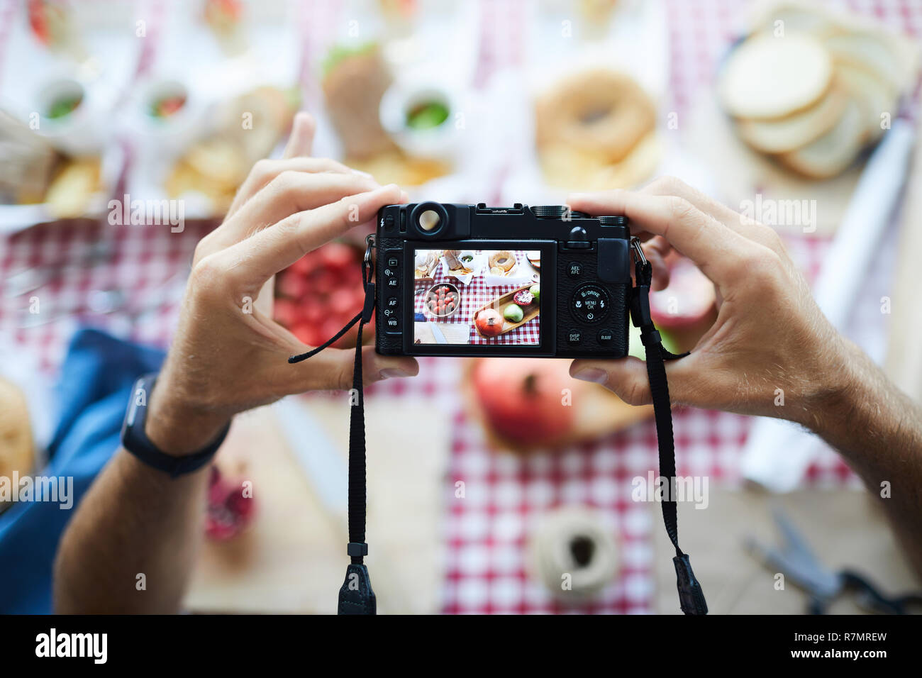 Top view closeup of photographer holding camera while taking pictures ...