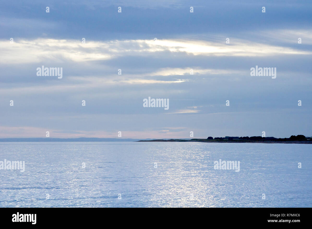 A calm end to a winter's day with an overcast but broken sky being ...