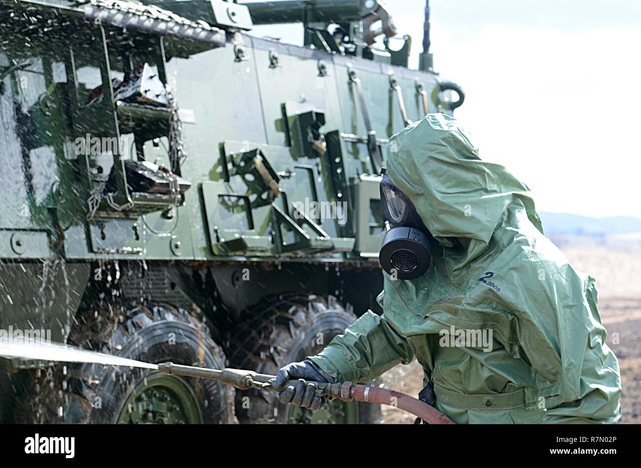 A Slovakian CBRN Soldier conducts decontamination procedures on a U.S ...