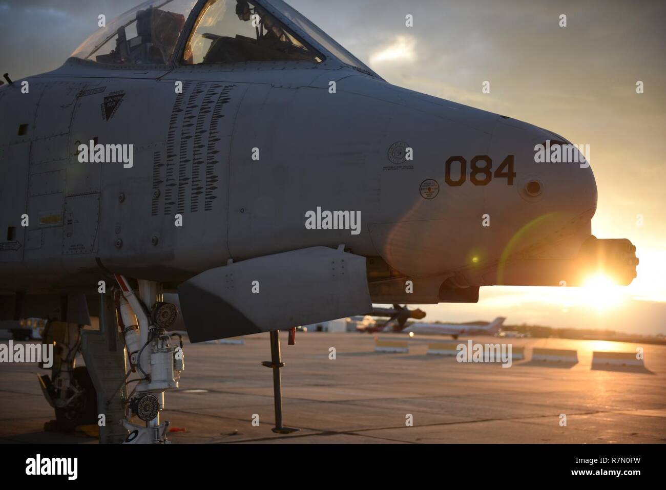 Several A-10 Thunderbolt II aircraft wait for a sunset take off during ...