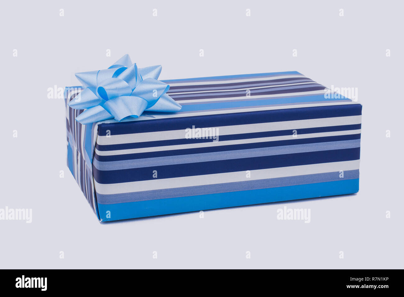 Blue striped gift box with bow. Present box wrapped in blue paper with ...