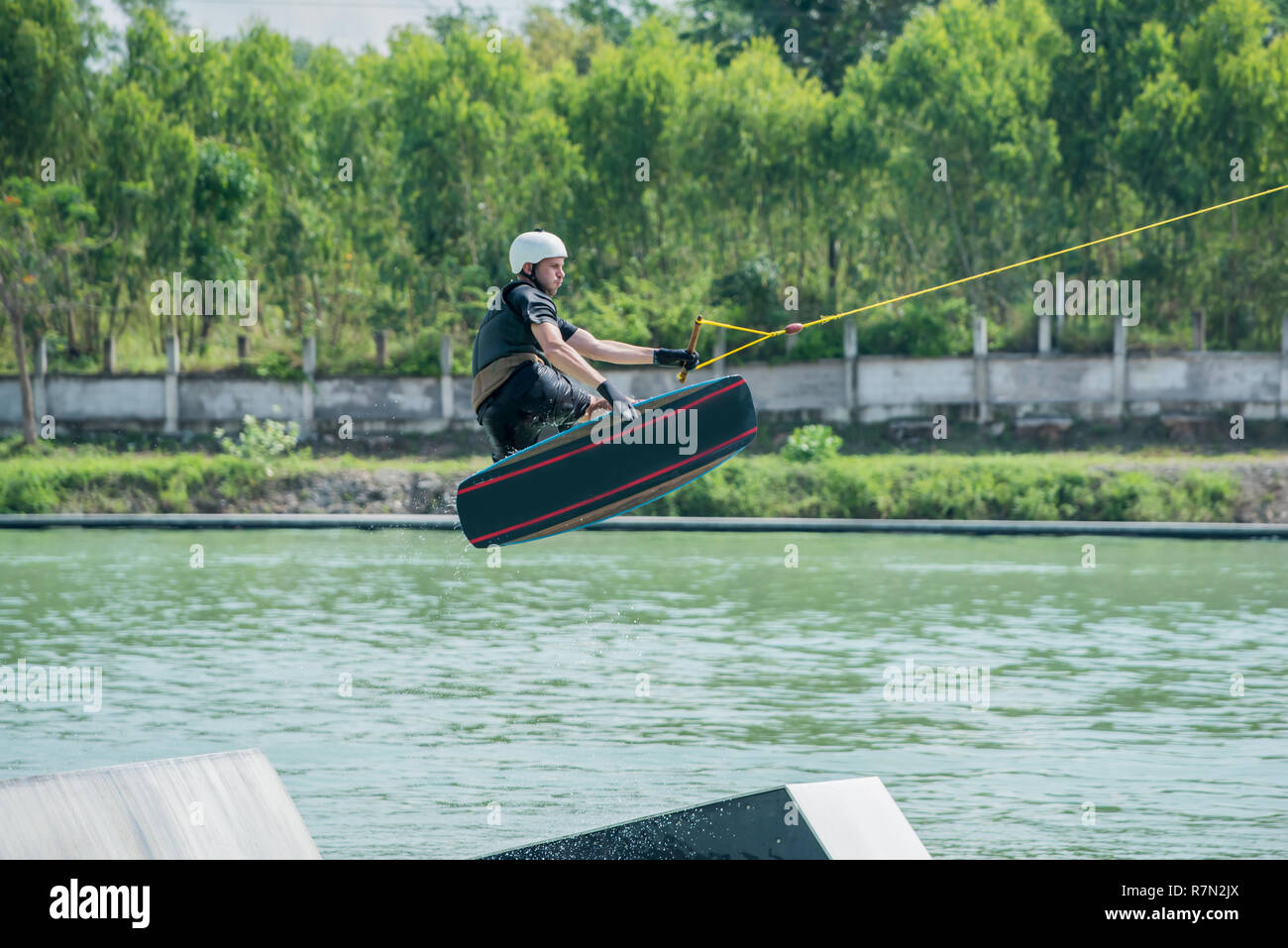 wakeboarding at the wake park. Outdoor and extreme water sport. Summer ...