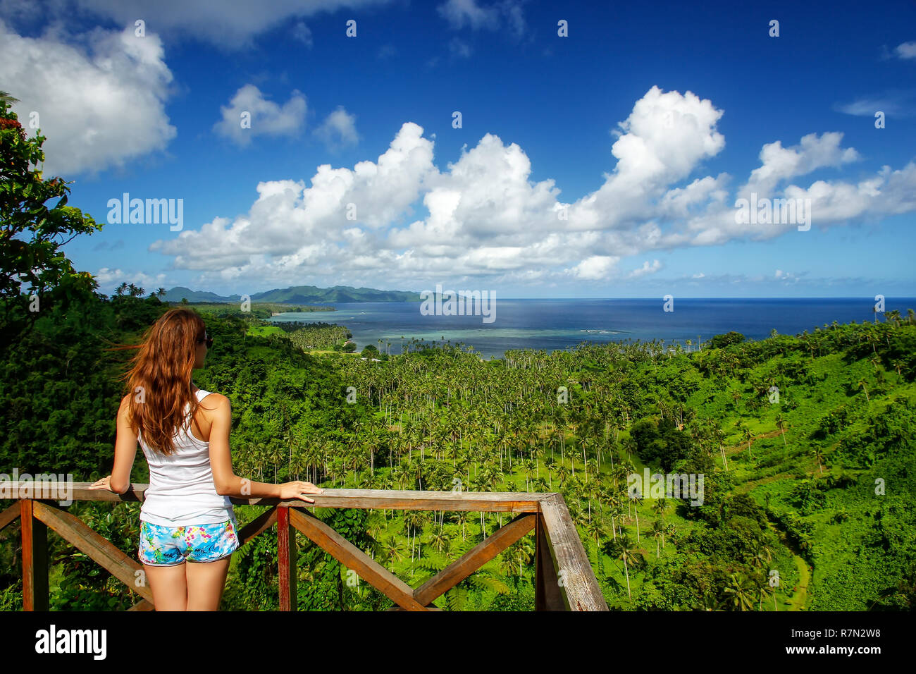 Young woman standing at the viewpoint in Bouma National Heritage Park ...