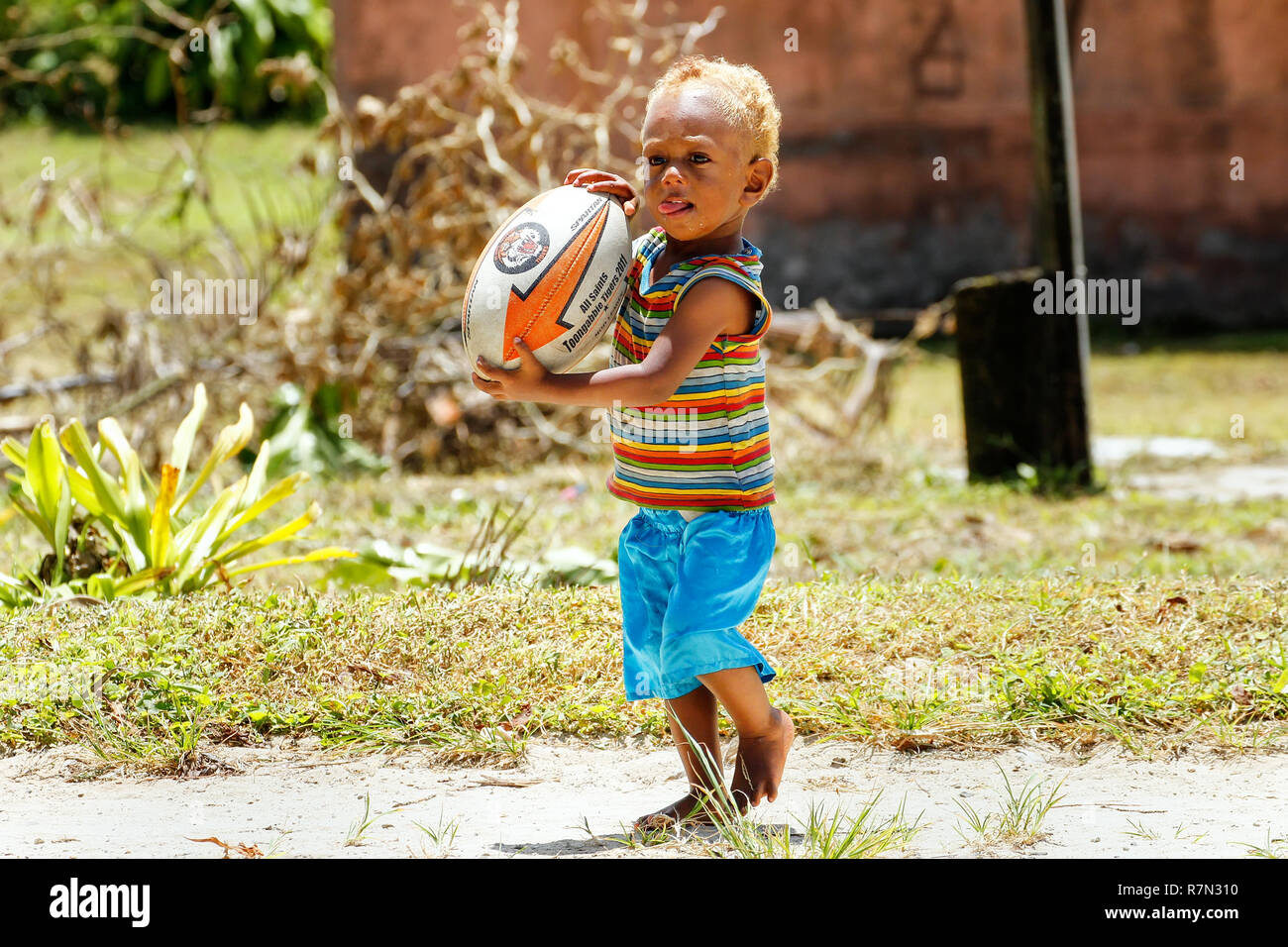 Young boy playing with rugby ball in Lavena village, Taveuni Island ...